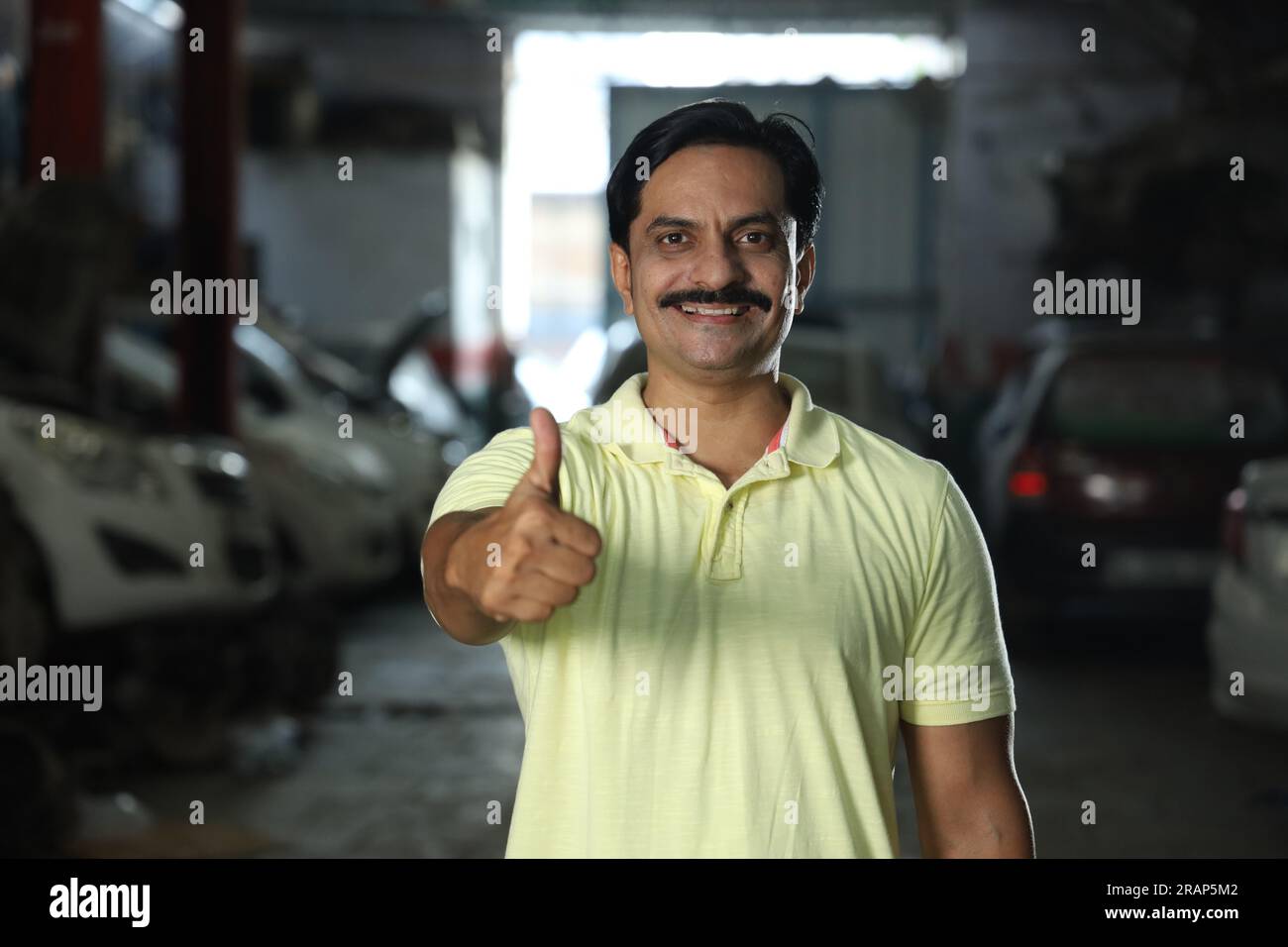 Indian happy female customer showing a thumbs up for repairing the car ...