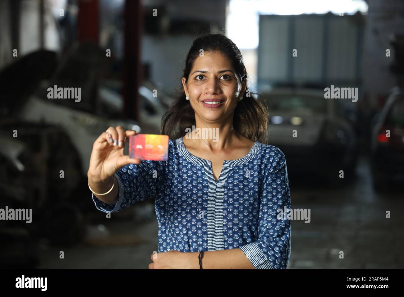Indian happy customer showing the credit or a debit card for digital ...