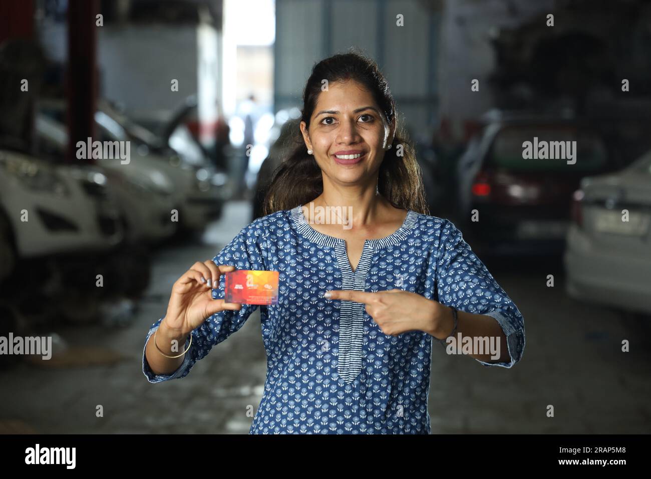 Indian happy customer showing the credit or a debit card for digital ...