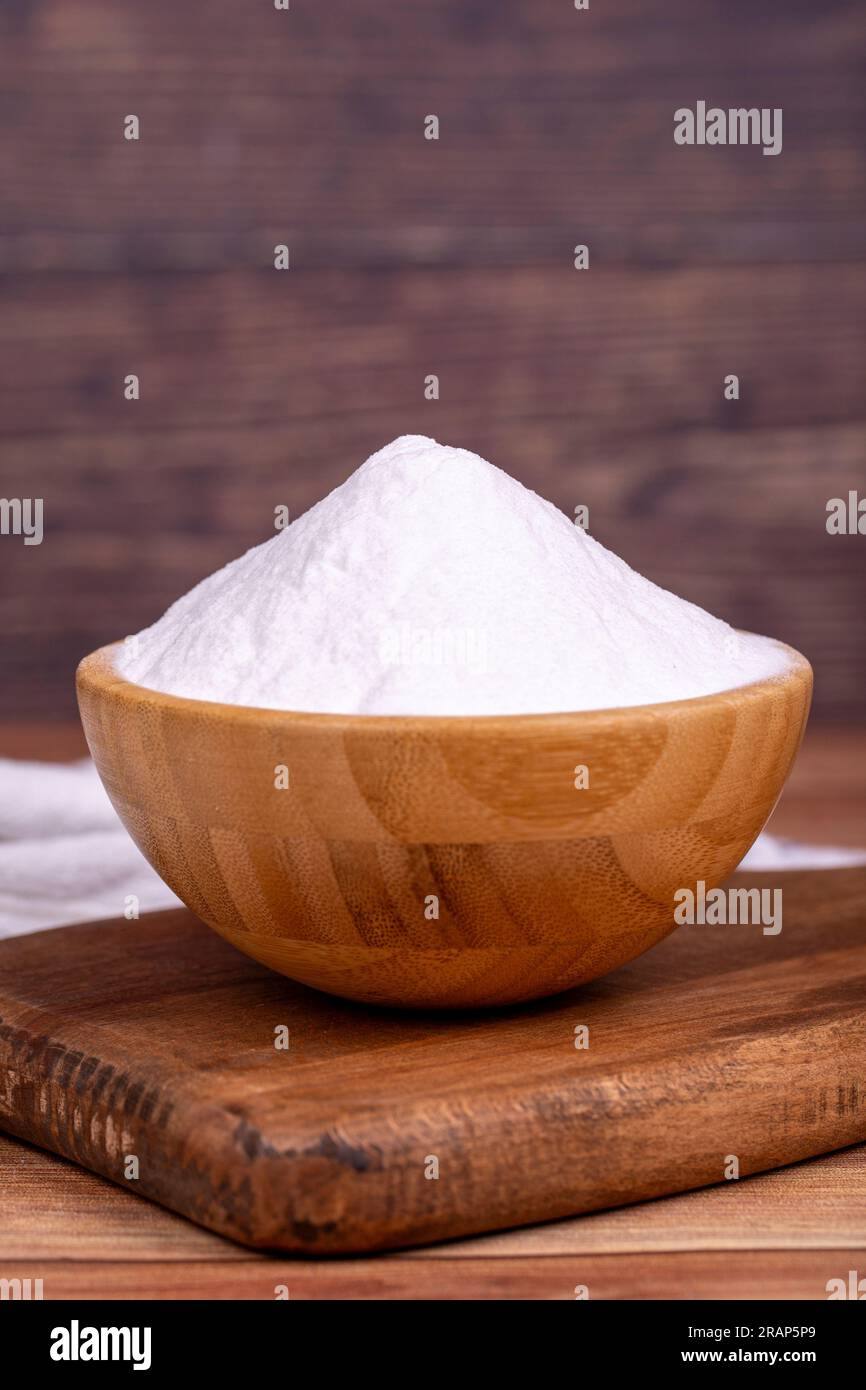 Sodium bicarbonate or baking soda on wood background. Sodium ...