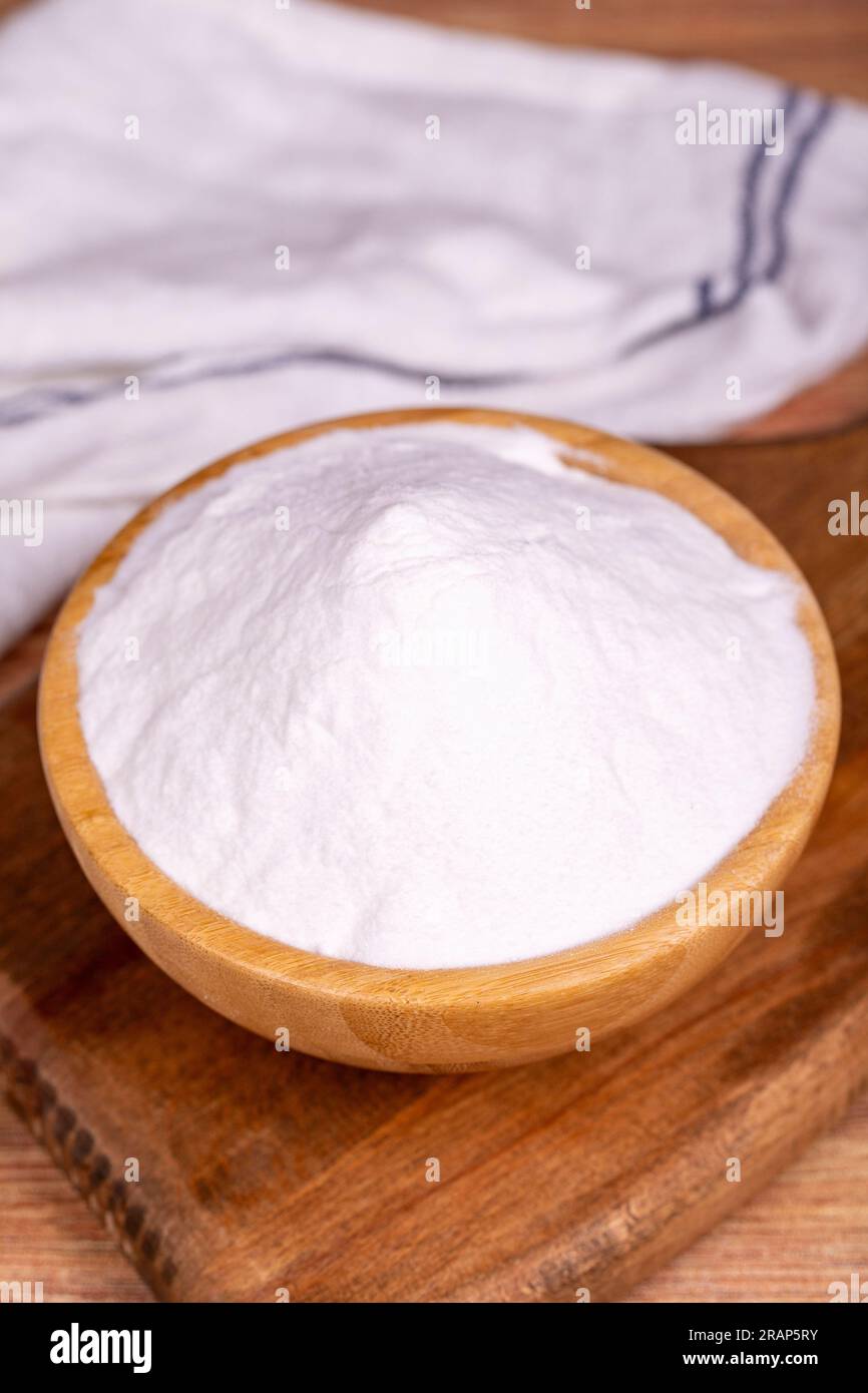 Sodium bicarbonate or baking soda on wood background. Sodium ...