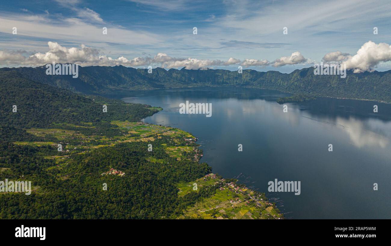 Aerial drone of blue lake Maninjau in a crater among the mountains ...