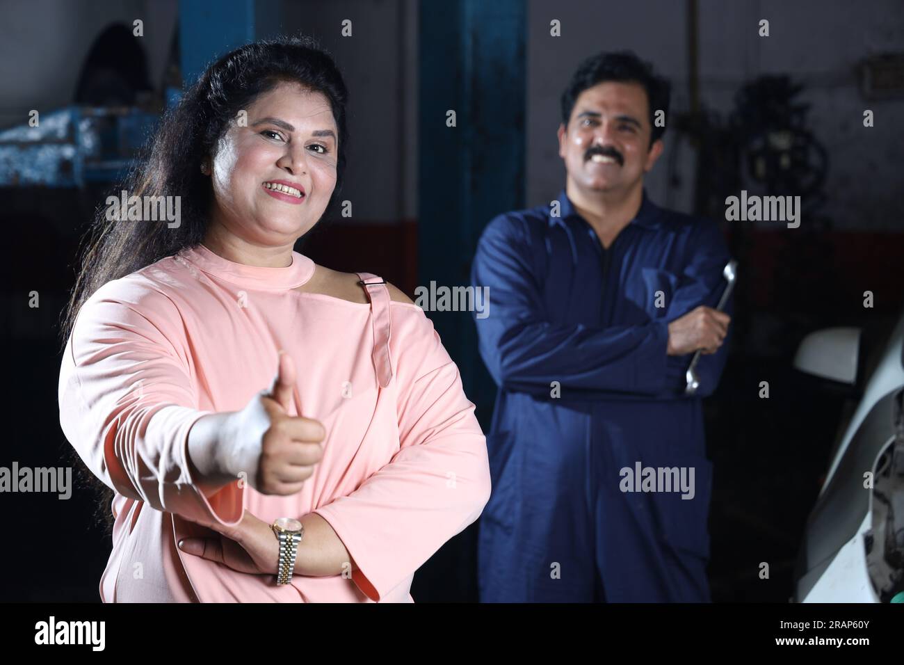 Indian happy female customer showing a thumbs up for repairing the car ...