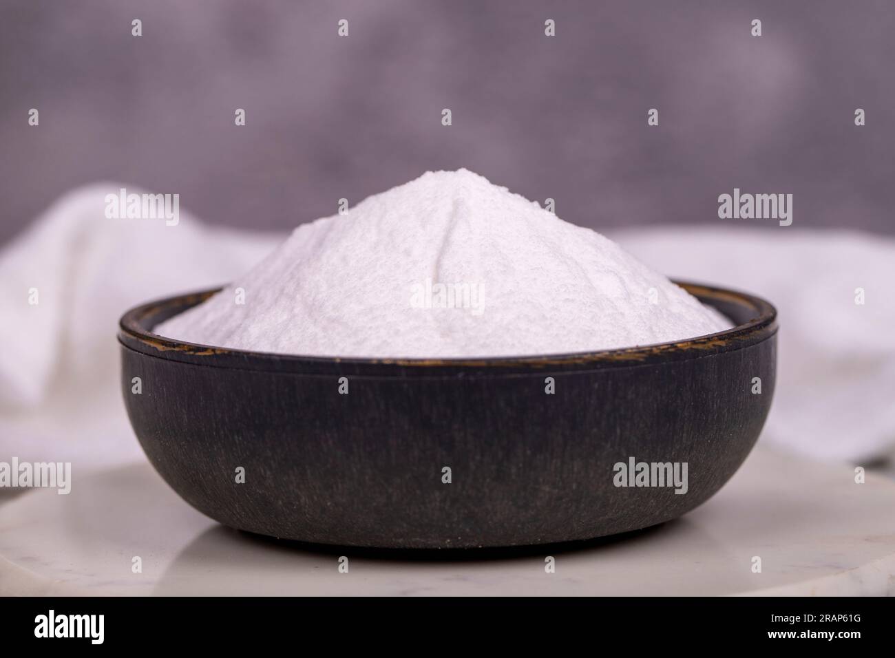 Sodium bicarbonate or baking soda on grey background. Sodium ...