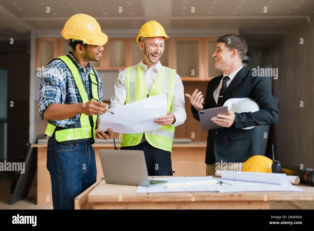 multi ethnic engineer brainstorming and measuring for cost estimating ...