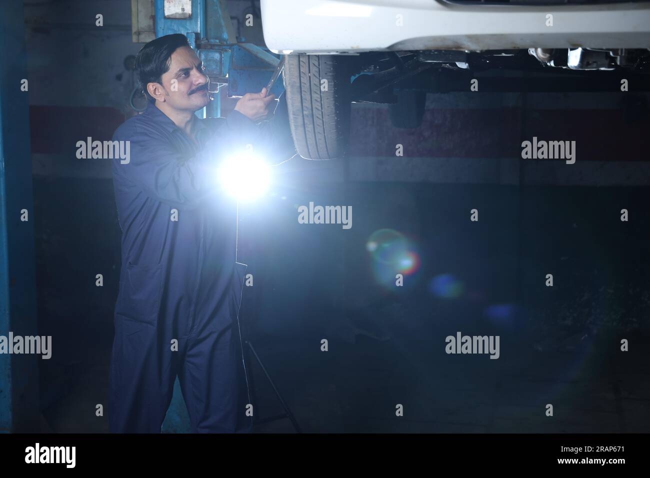 Mechanic working hard on car hi-res stock photography and images - Alamy