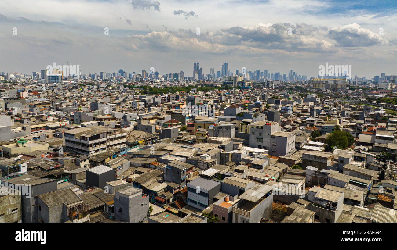Houses in the slums of Jakarta and the panorama of the city. Indonesia ...