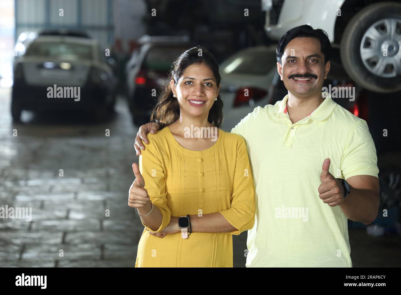 Indian happy female customer showing a thumbs up for repairing the car ...