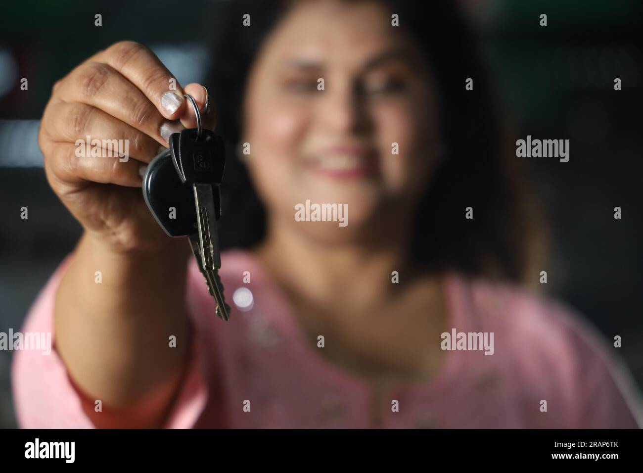 Indian happy customer giving the car keys to the mechanic. Portraying ...