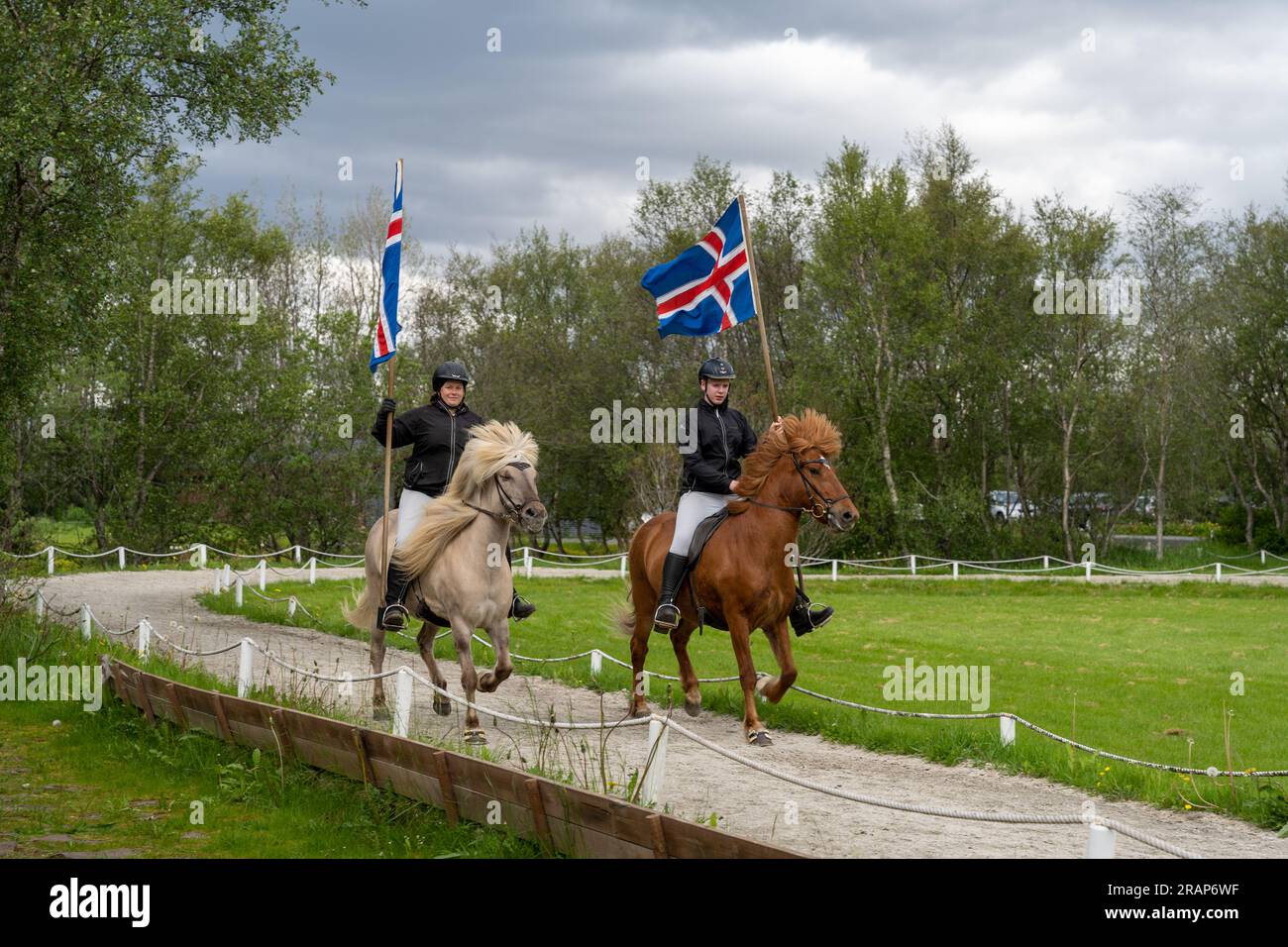 Reykholt, Iceland - 06.24.2023: Two horse riders holding flags of ...