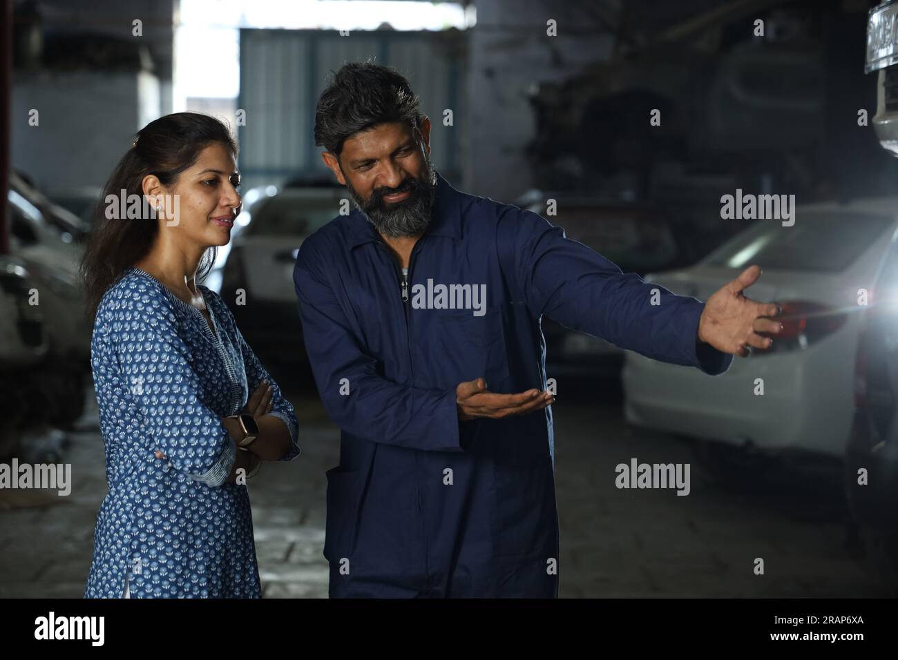 car mechanic standing with the happy customer shaking hands together ...