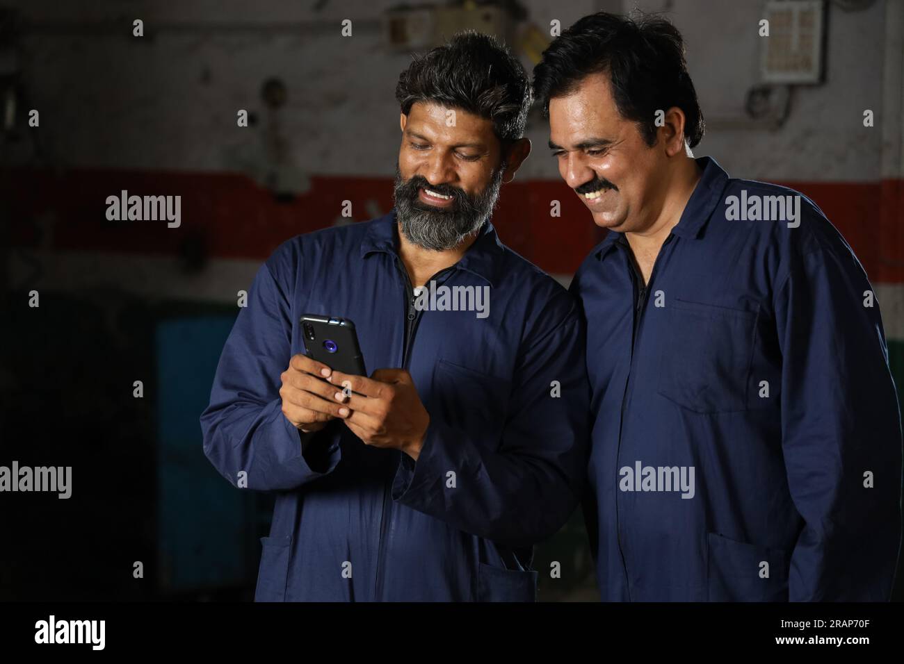 Happy Indian professional car mechanic in car repair men uniform ...