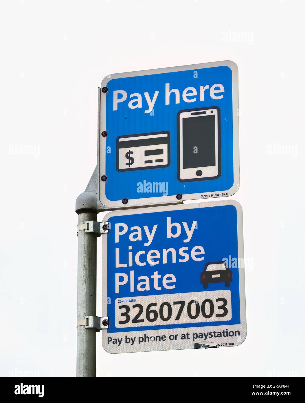 Street parking signs with instructions to pay by phone or paystation on ...