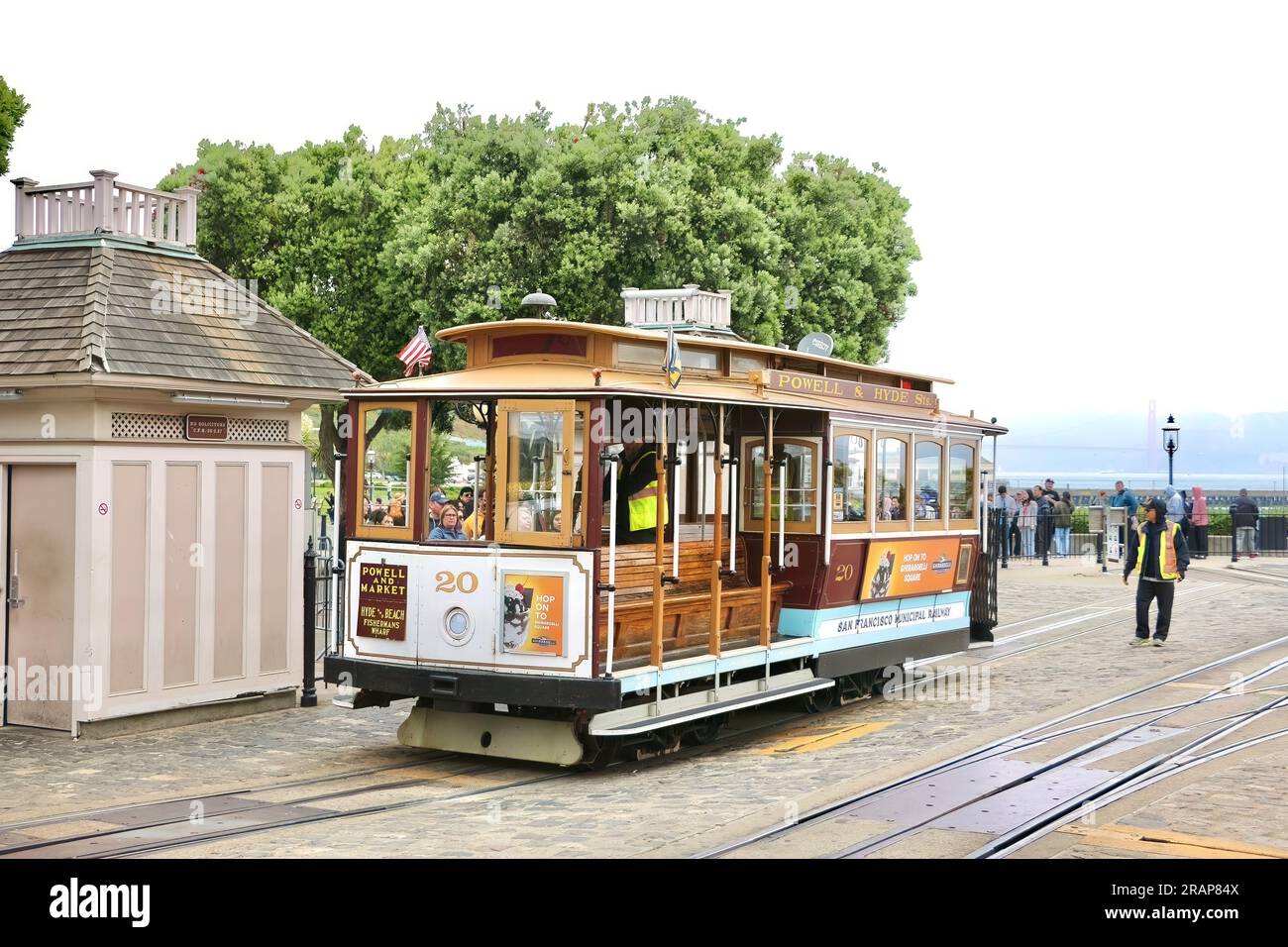 Tourists boarding an antique cable car at the Powell/Hyde Cable Car ...