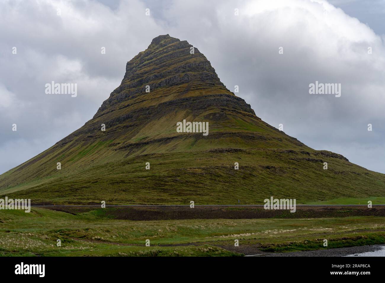 Kirkjufell mountain in Iceland, overcast sky in background Stock Photo ...