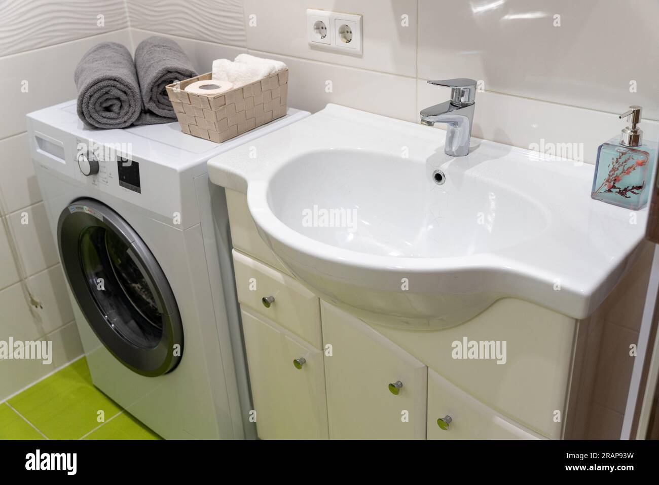 Interior of bathroom with white sink and washing machine Stock Photo ...