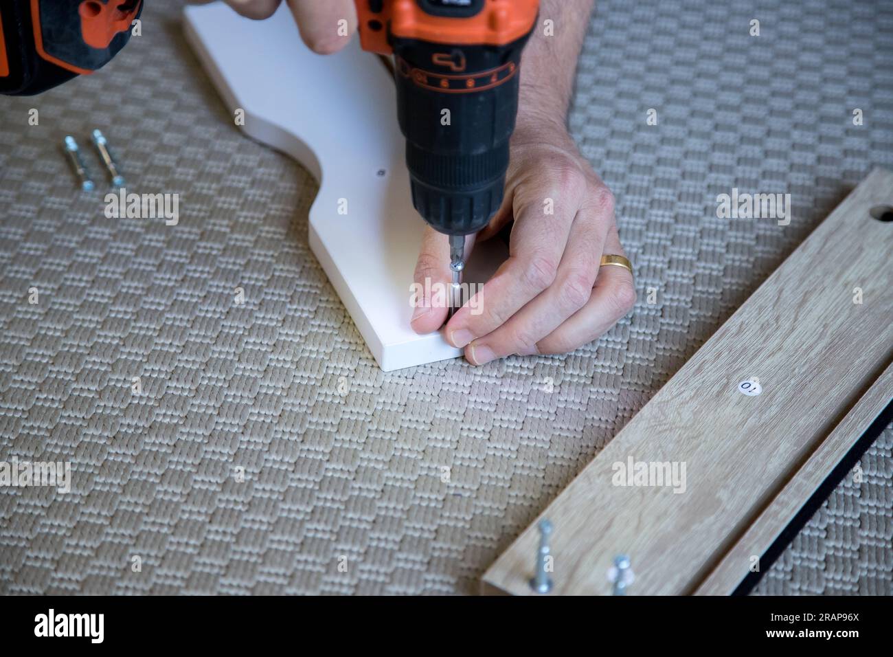 DIY moment detail indoors. Person following the steps to build a mdf ...