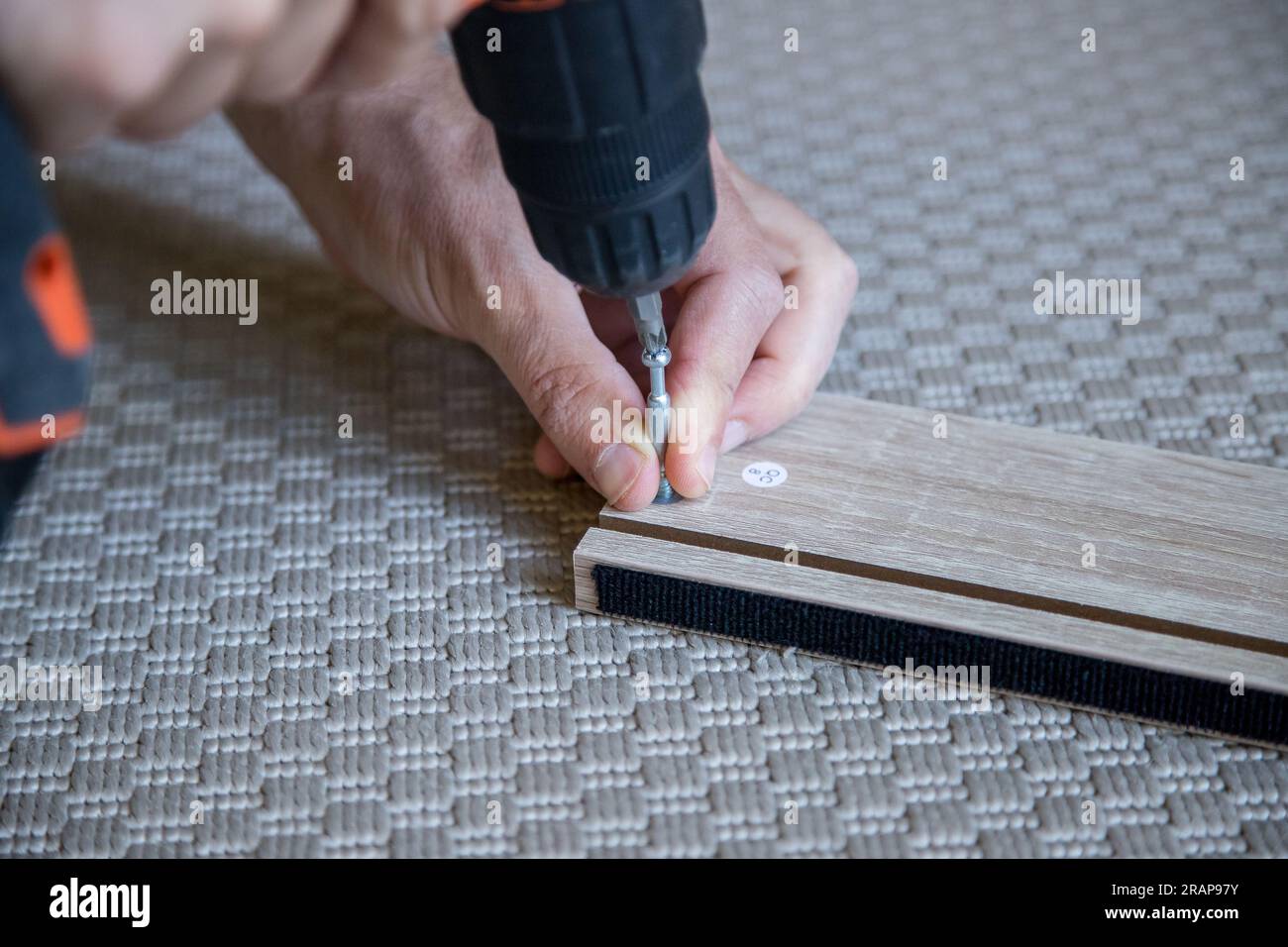 DIY moment detail indoors. Person following the steps to build a mdf ...