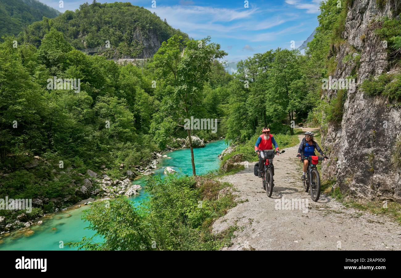active senior couple on a e-bike tour in the Valley of River Soca, Triglav National Park near ...