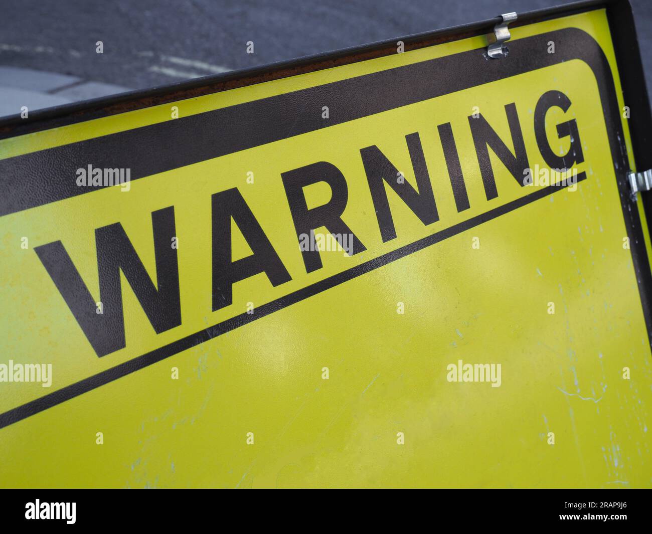 yellow and black warning sign with copy space Stock Photo - Alamy