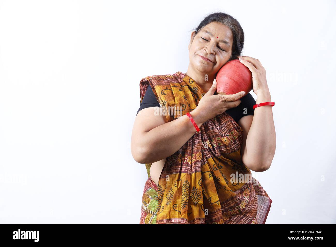 Happy rural Indian old lady in saree standing in white background ...