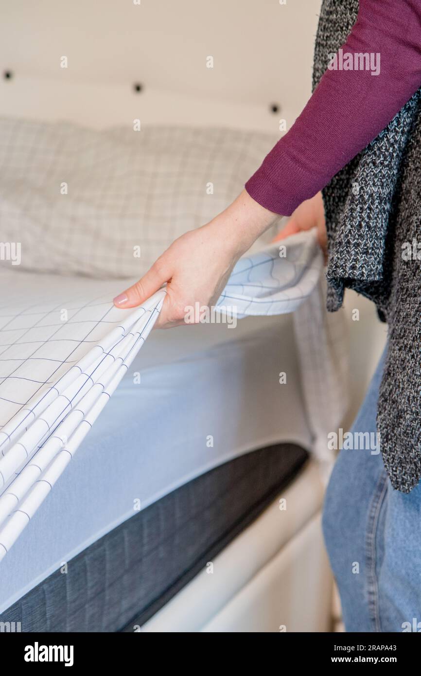 Detail of person making the bed. Concept of home life, daily activities ...