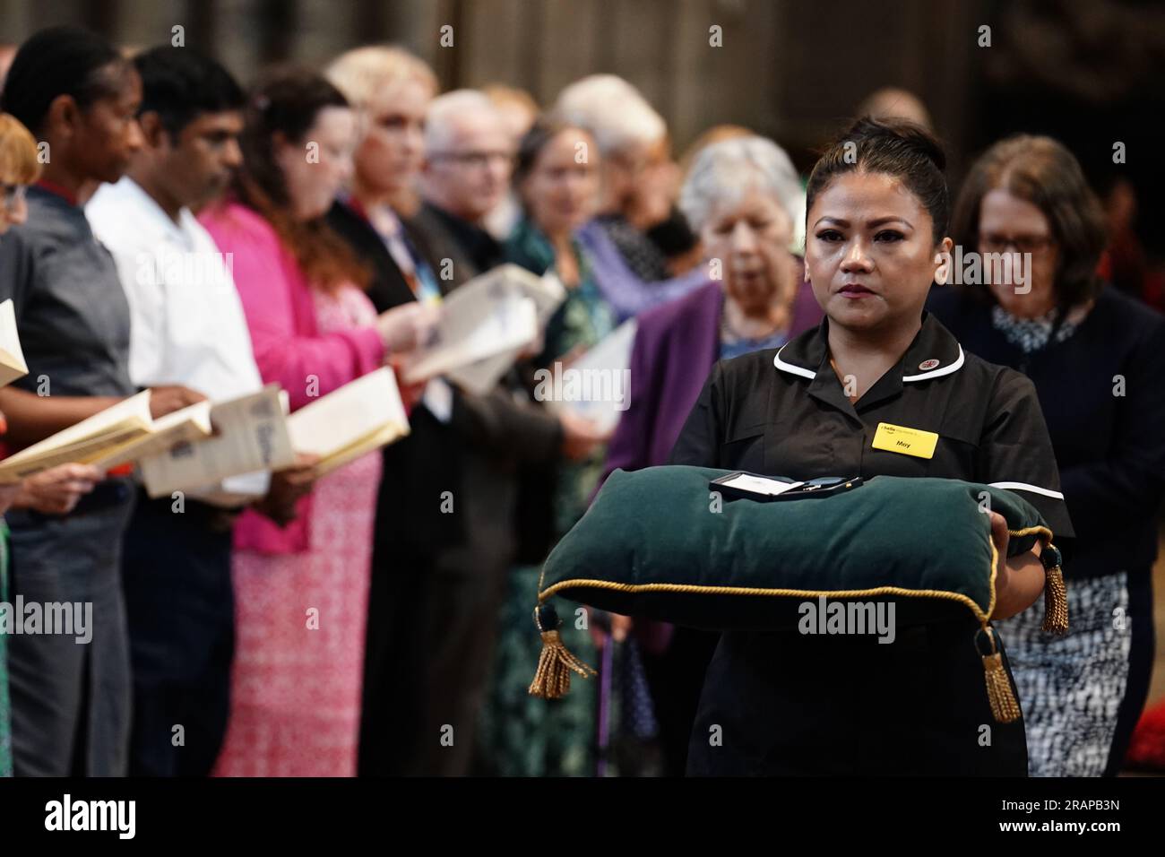 Nurse May Parsons in the procession at the start of the service ...