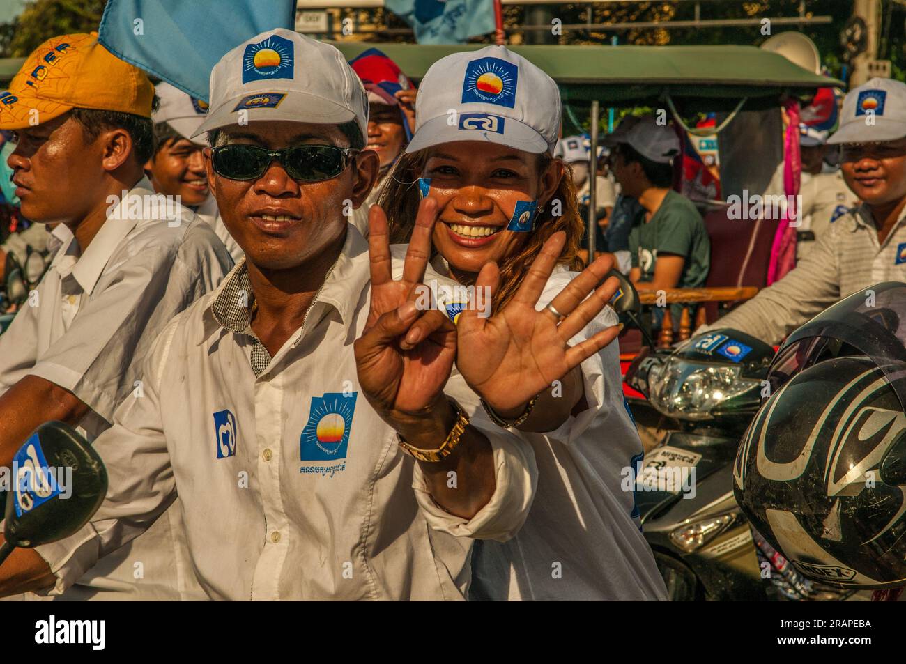 A Cambodian couple, Sam Rainsy supporters, showing #7 w/ their hands ...