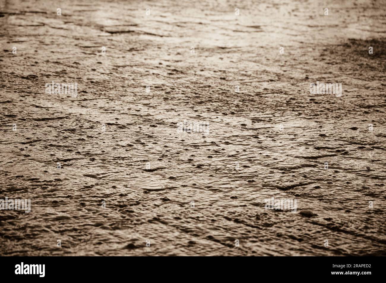 Rainy background with rain water circle splashes on the cobblestone of ...