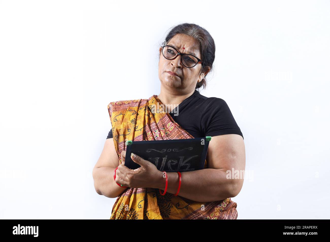 Old rural Indian lady holding a writing board in hand wearing a saree ...