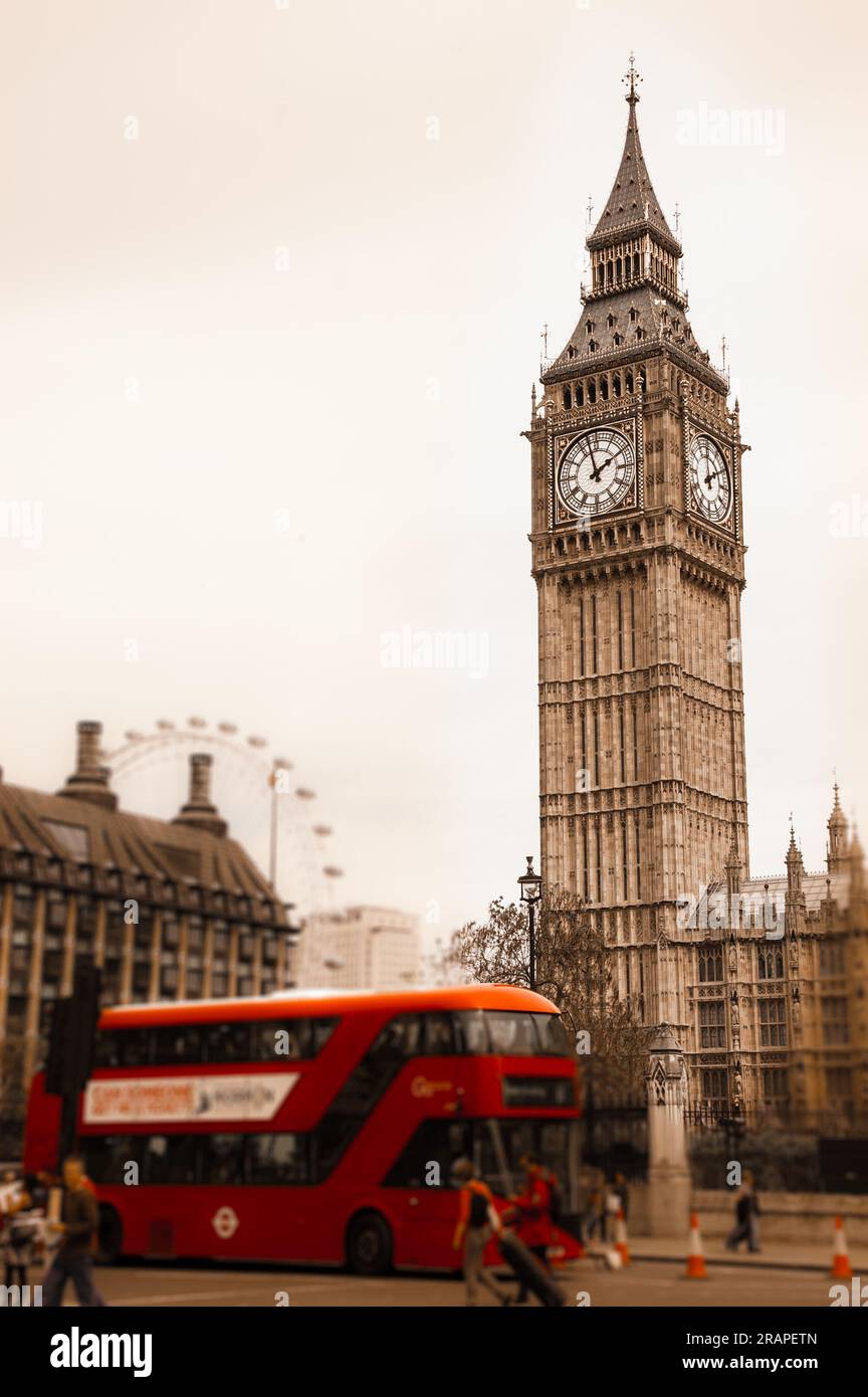 Big Ben and blurred red double decker bus, tourists and London Eye ...