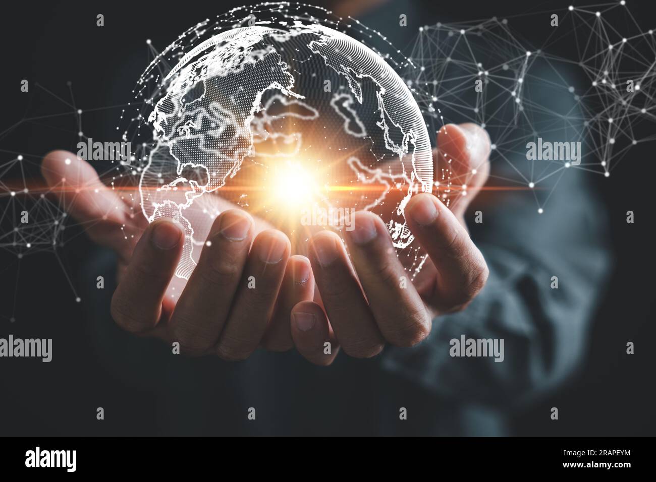 A businessman's hand holds a globe, illustrating seamless connectivity ...