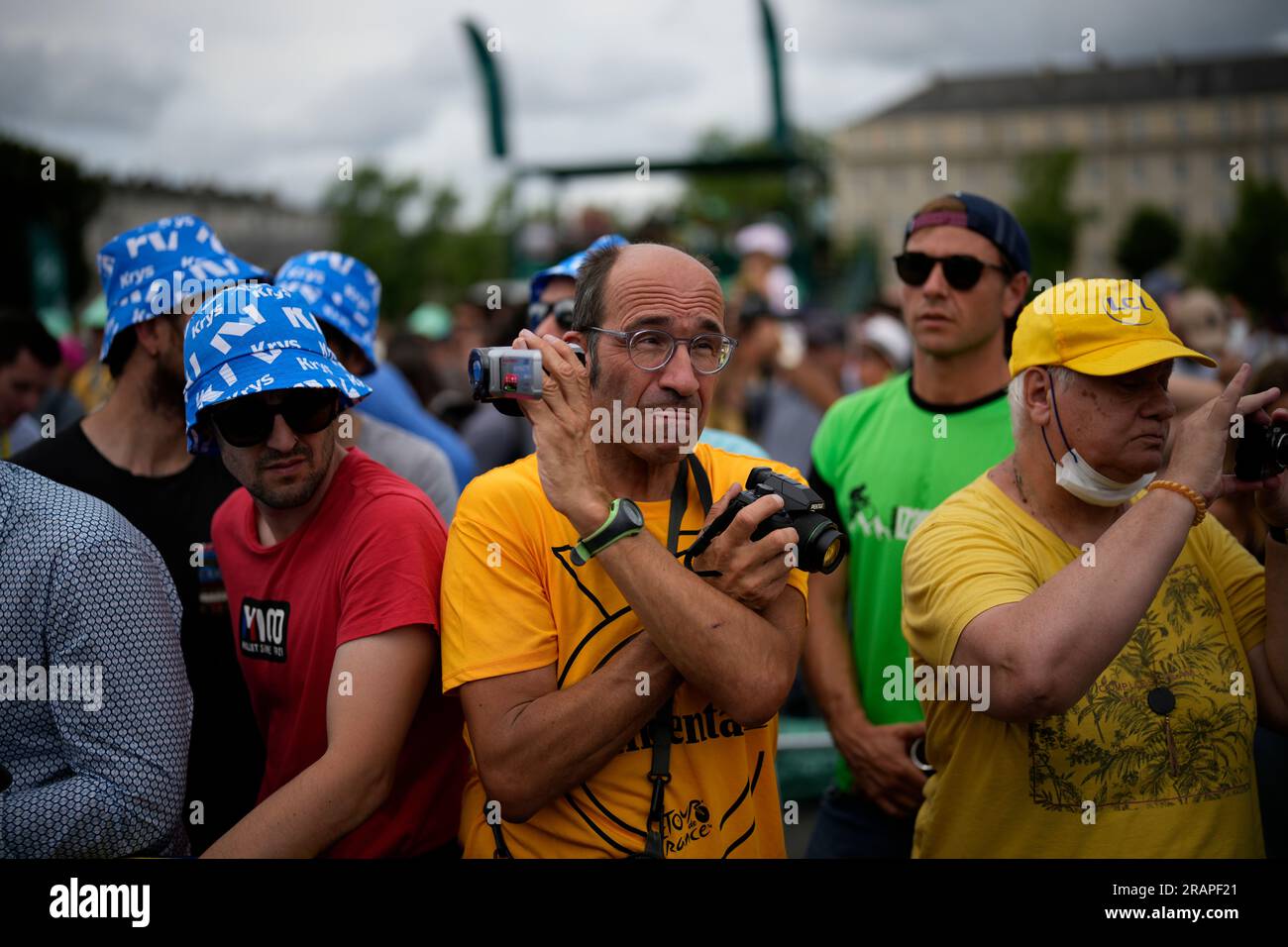 A cycling fan takes pictures and video images of the cyclists prior to ...