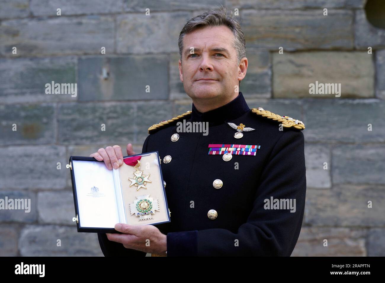 Lieutenant General Sir Nicholas Borton holds his medal after being made ...