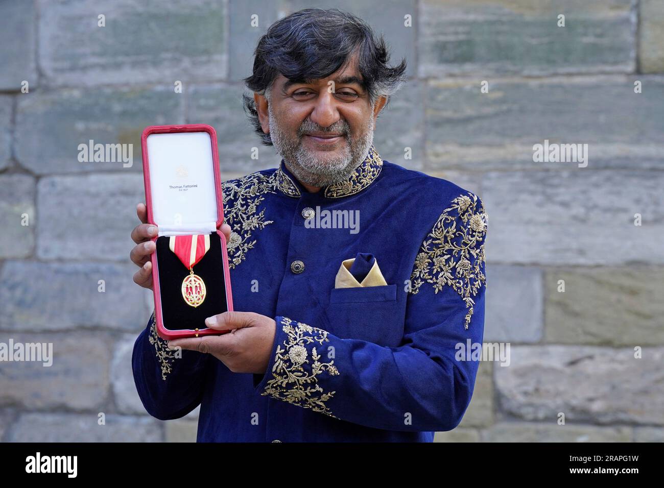 Professor Aziz Sheikh holds his medal after being made a Knight ...