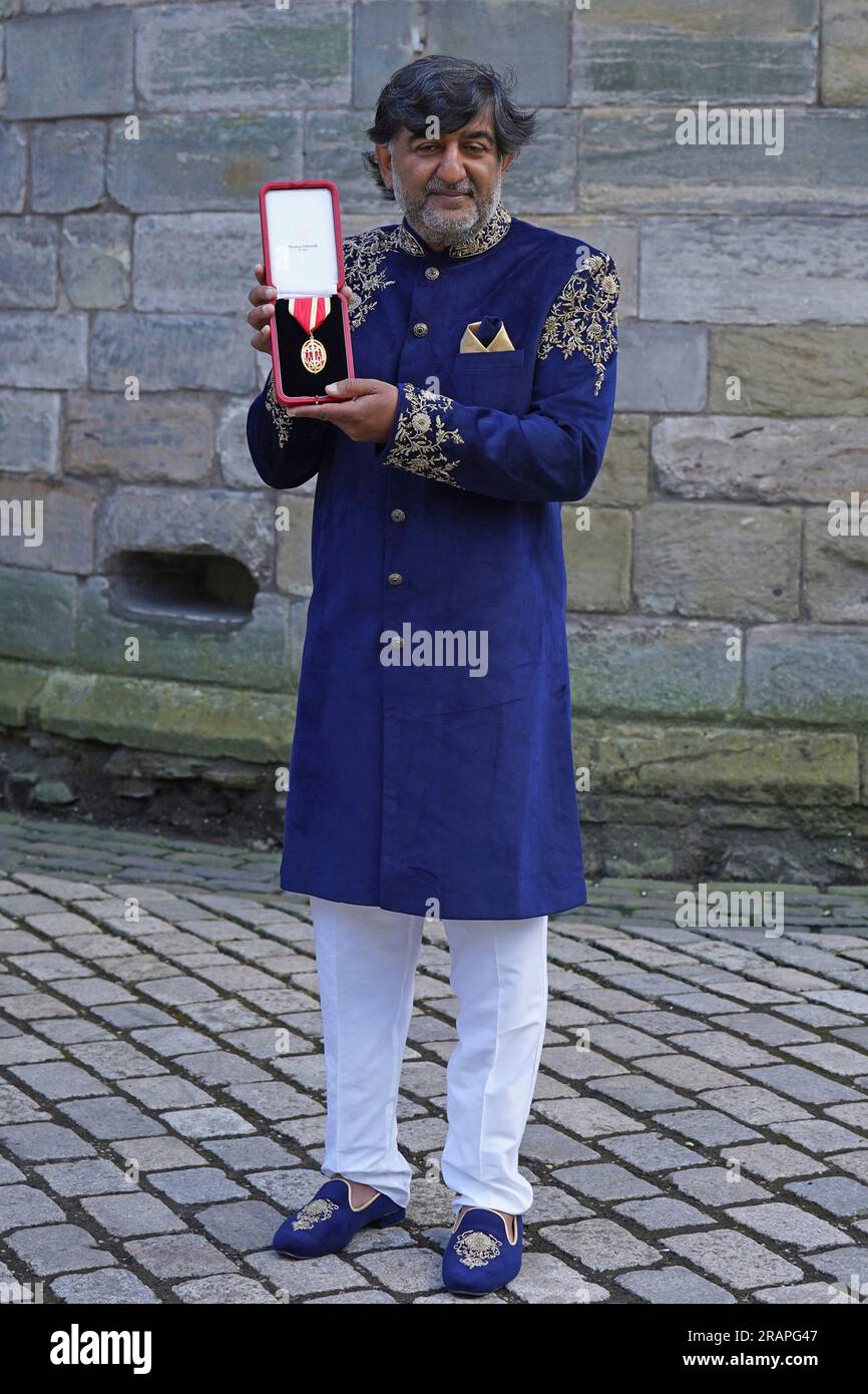 Professor Aziz Sheikh holds his medal after being made a Knight ...