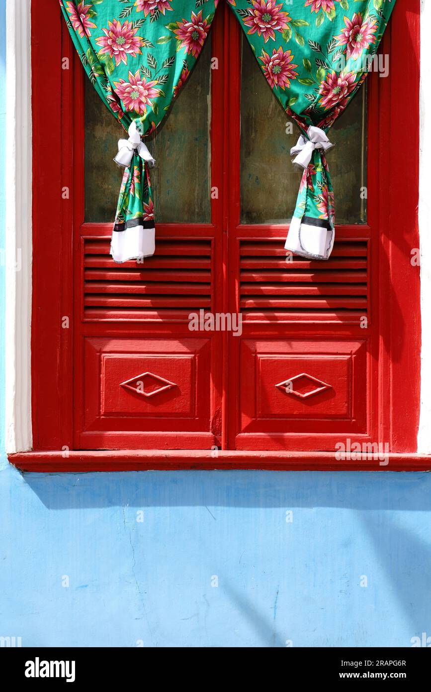 Colorful Red Window with Green Flowered Curtains and Blue Facade Stock ...