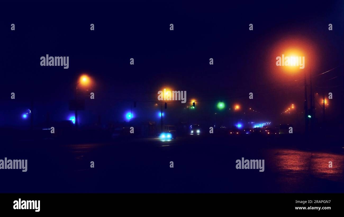 Night freeway highway with wet asphalt and shining blue orange lights ...