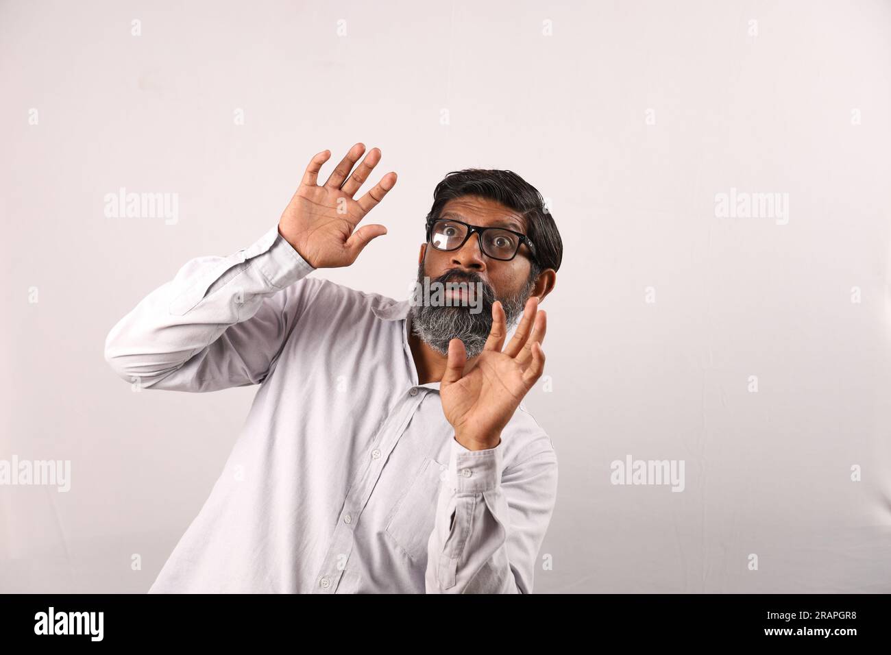 Portrait of an Indian bearded man wearing shirt. Funky expressions sad ...