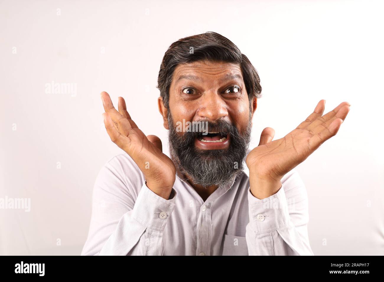 Portrait of Indian bearded man surprised. Funky expressions portraying ...