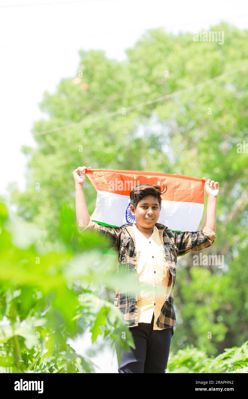 Indian boy holding national flag in farm, happy boy, national flag ...