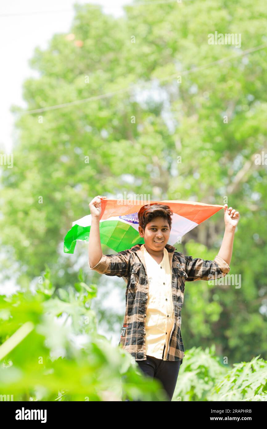 Indian boy holding national flag in farm, happy boy, national flag ...