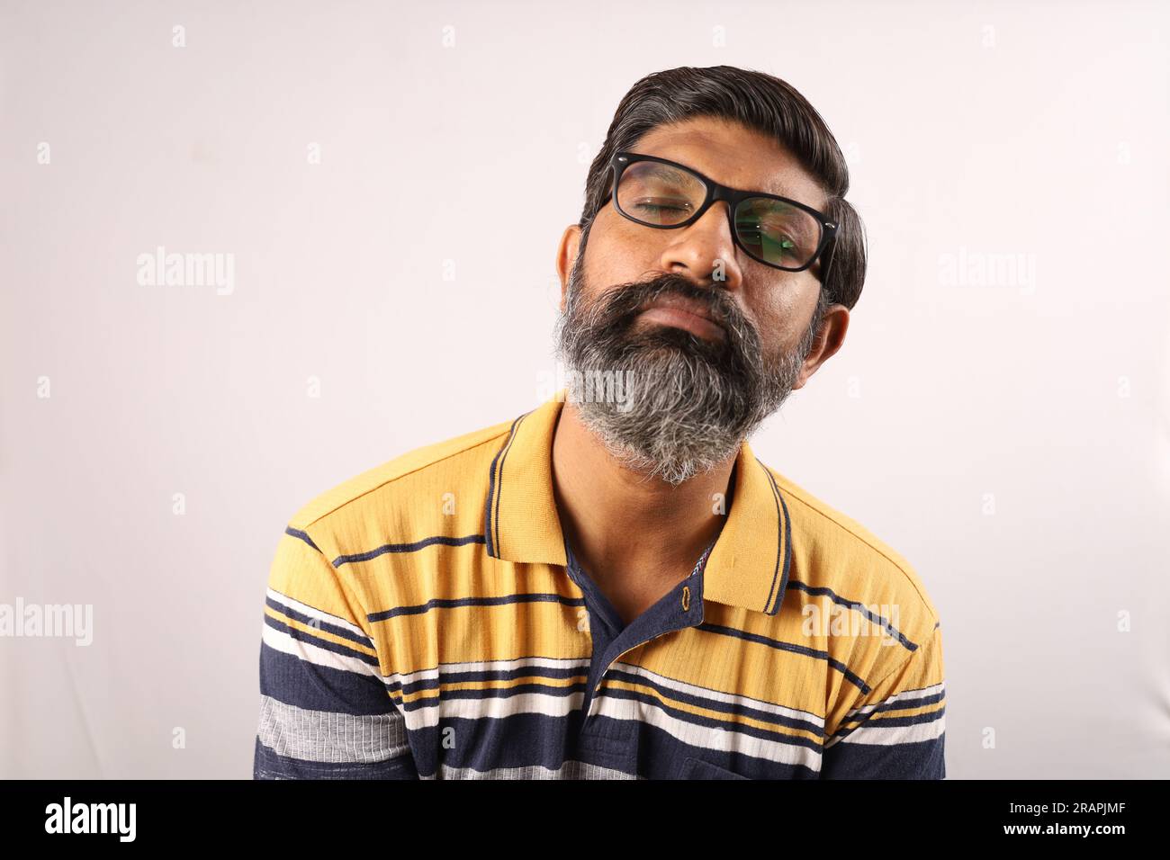 Portrait of an indian bearded man wearing specs and t shirt hi-res ...