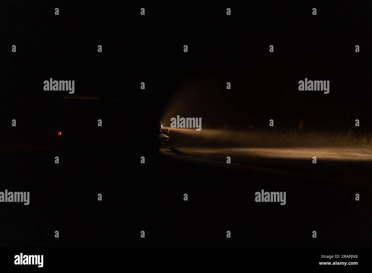 Front view of car with headlights on in the night. Tourism safari ...