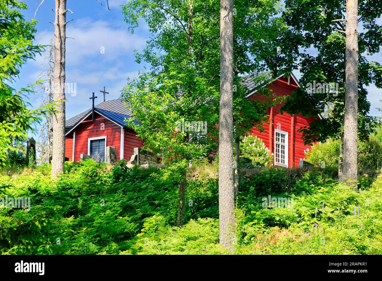 Red wooden Karkola church, built 1842, and bell tower in rural ...