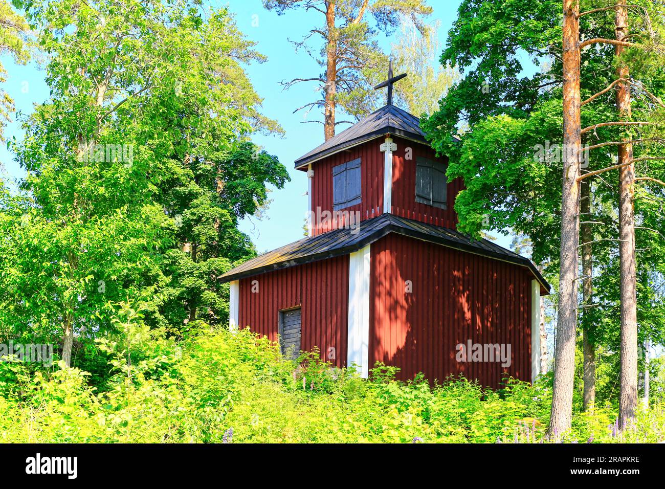 Red wooden Karkola church bell tower, built ca 1860, rural environment ...