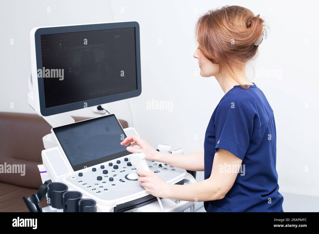 Doctor woman in uniform sitting in office in hospital with ultrasound ...