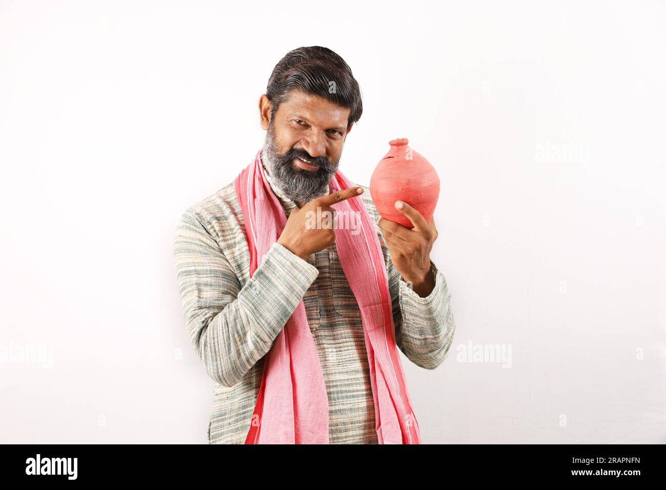 Indian bearded villager saving in piggy bank hi-res stock photography ...