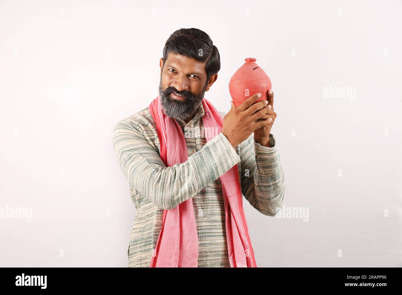 Indian bearded villager saving in piggy bank hi-res stock photography ...