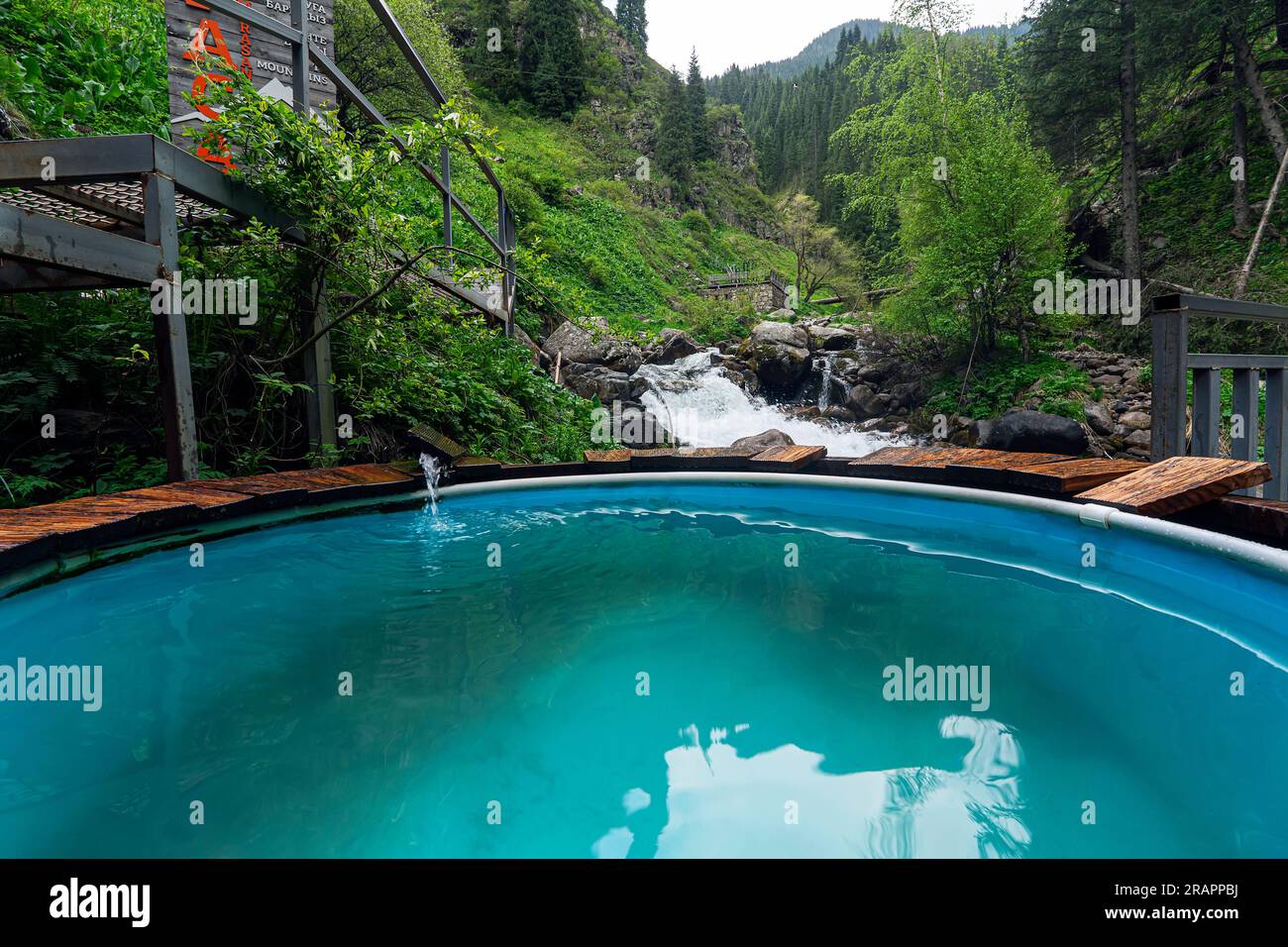 Hot springs geothermal water in mountains. Vat with hot geothermal ...